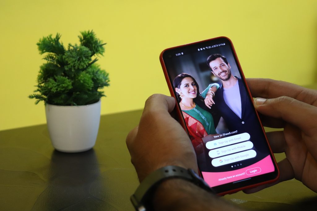Indian marriage app Shaadi.com app login screen with beautiful indian ...