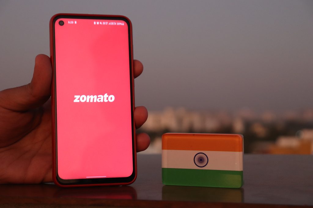 Indian hand showing food ordering and delivery platform zomato welcome ...